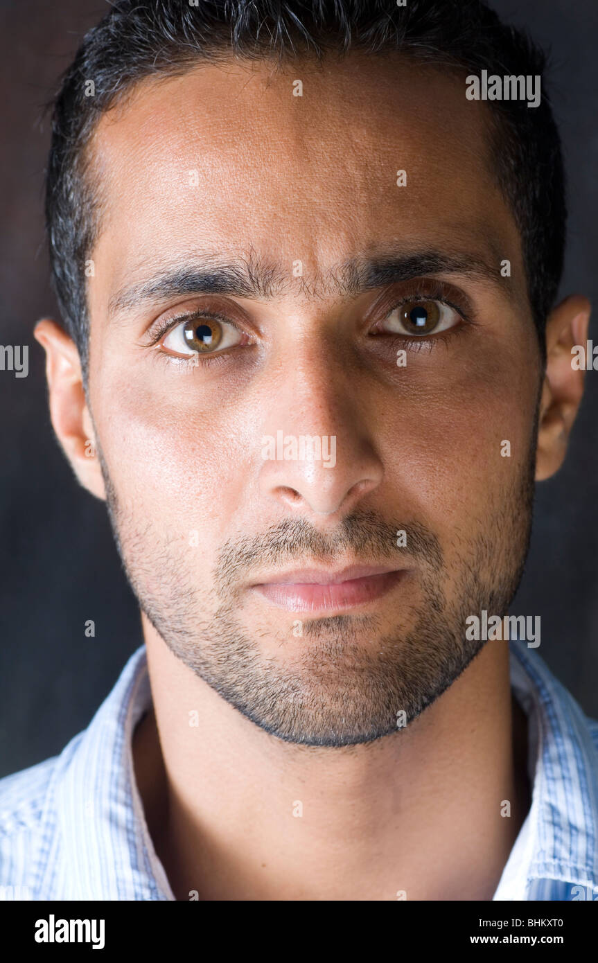Close up portrait of a young Arab man staring at the camera Stock Photo ...