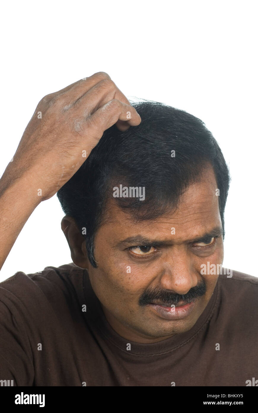 Indian man scratching his head against a white background Stock Photo ...