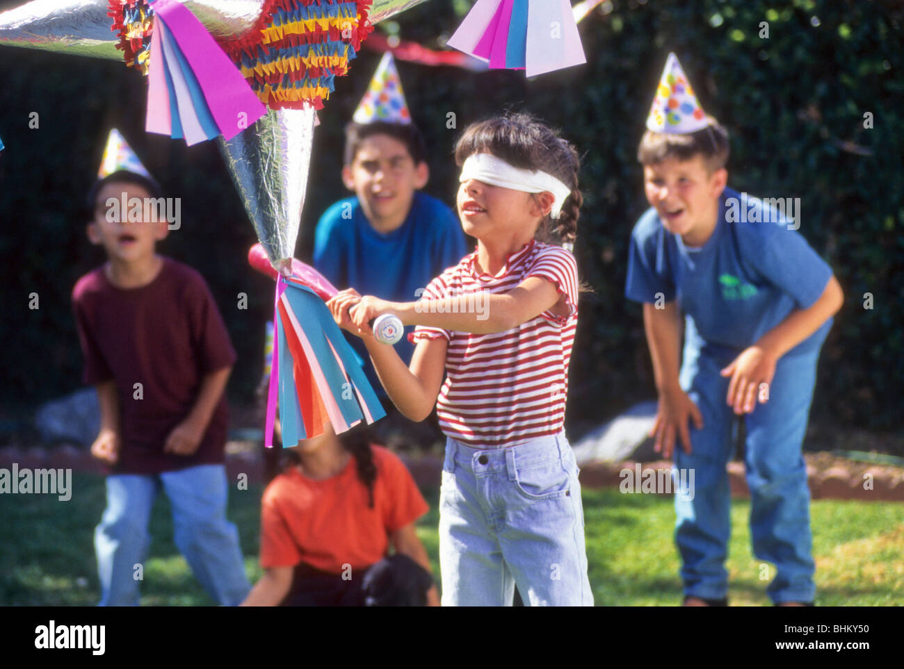 Kids hit Mexican pinata filled with candy at birthday party Stock Photo ...