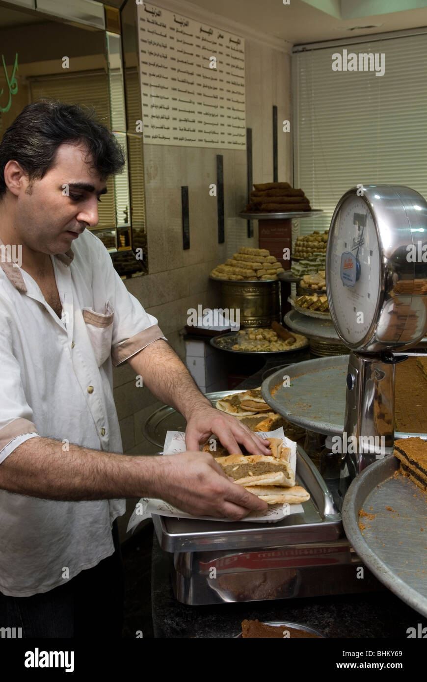 Man weighing food on scale in Lebanon Middle East Asia Stock Photo - Alamy