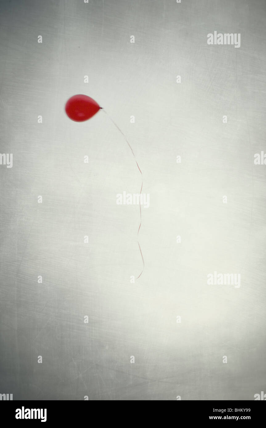 Blurred red balloon flying in the air Stock Photo - Alamy