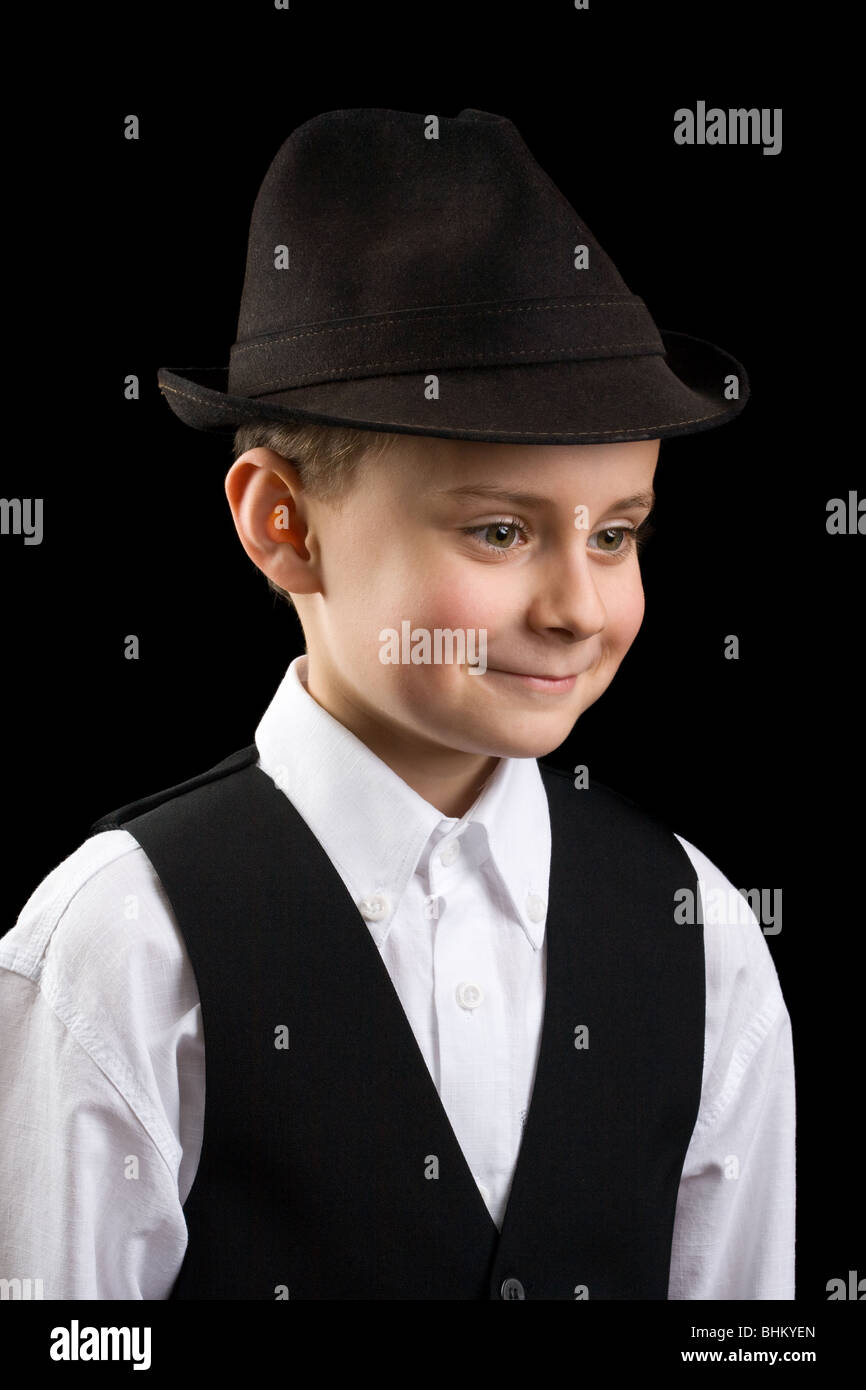 Portrait of a gorgeous little boy posing with hat, isolated on black ...