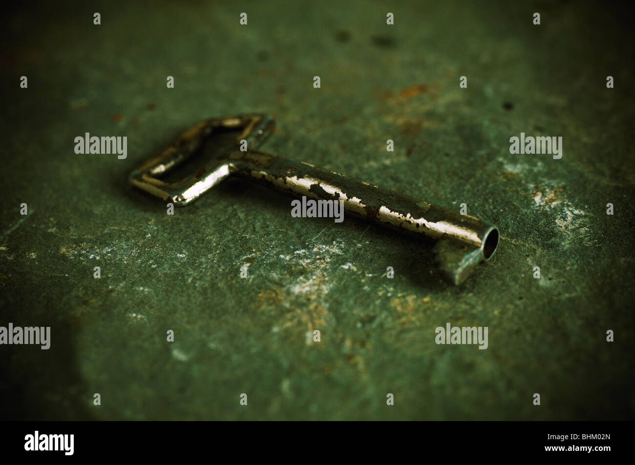 Old metal key on the ground outdoors Stock Photo - Alamy