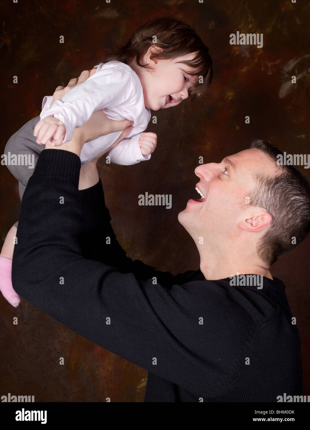 Proud daddy holding his four months old baby in his hands Stock Photo ...