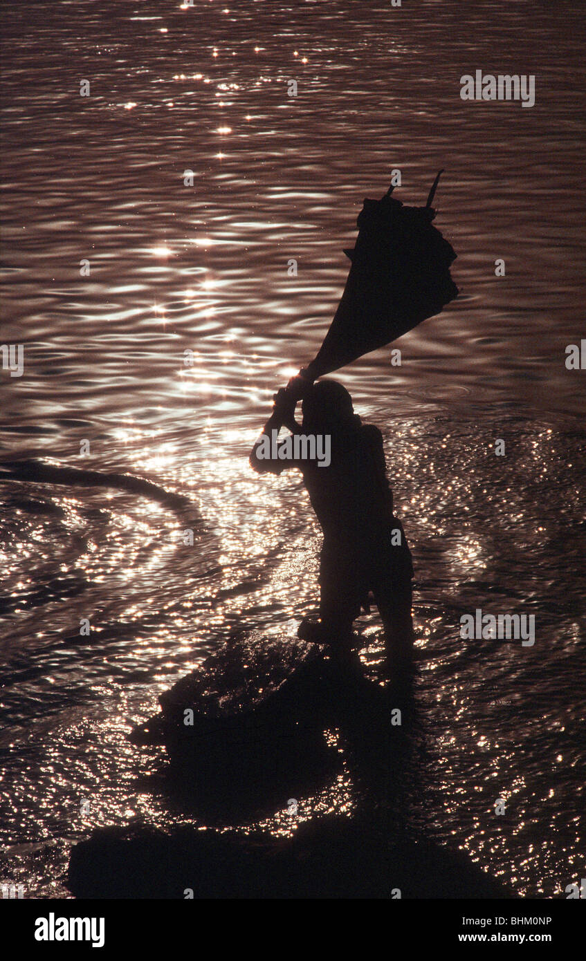 Dhobi Wallah on the Ganges washing clotes in the traditional way by ...