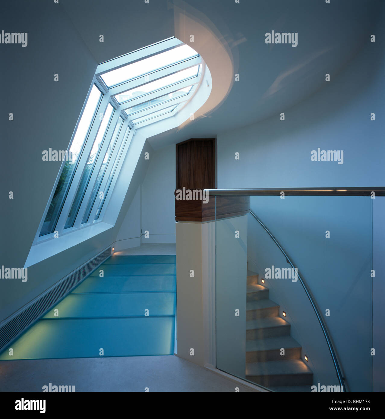 Sloping windows above modern landing Stock Photo - Alamy