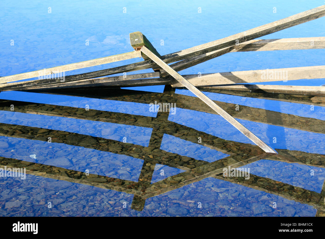 Fence falls into water Stock Photo - Alamy