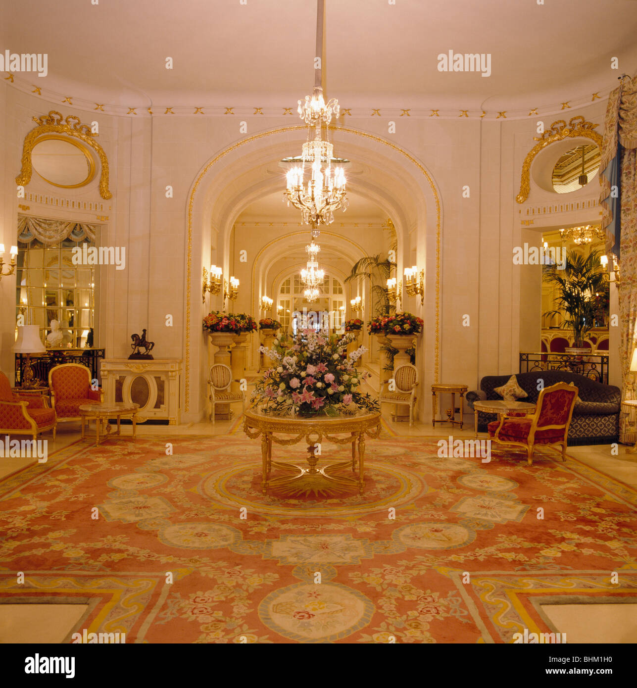 Lighted chandelier above circular table in large traditional hotel ...