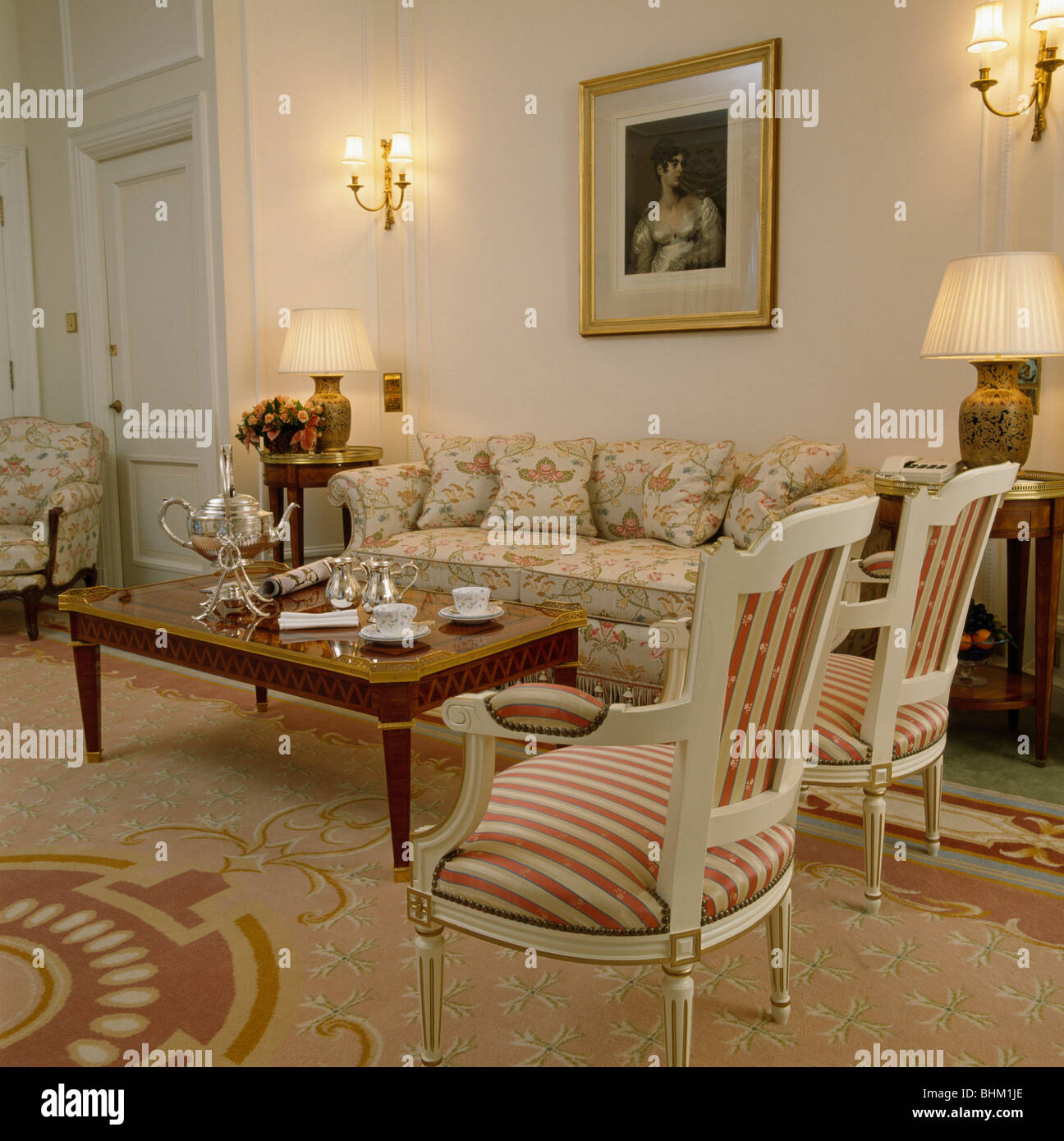 Silver samovar and tea-set on table in townhouse living room with ...