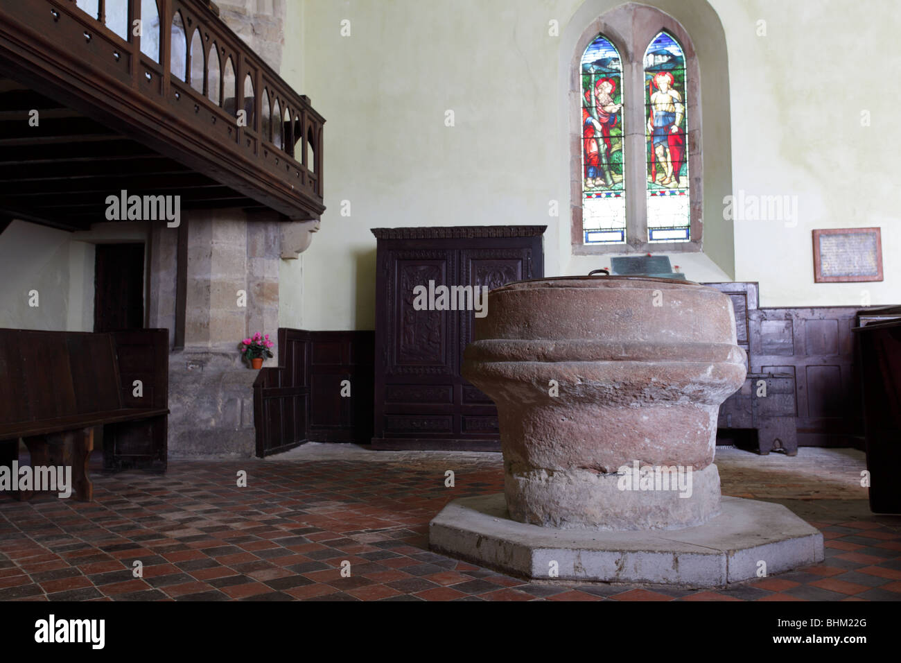The stone Font inside the village church of St Andrew`s in Wroxeter ...