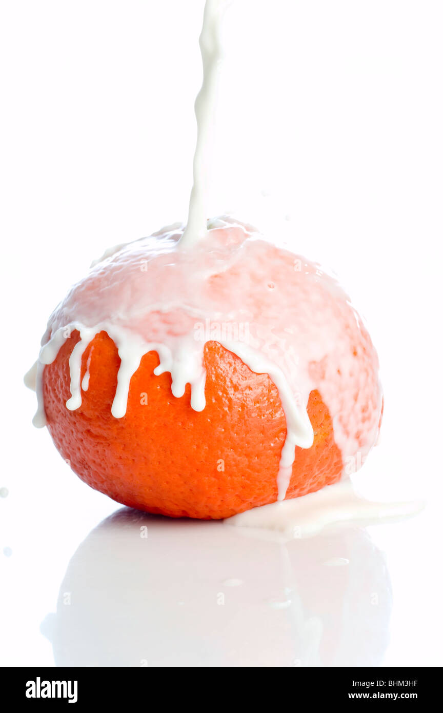 mandarine with splashing milk Stock Photo - Alamy