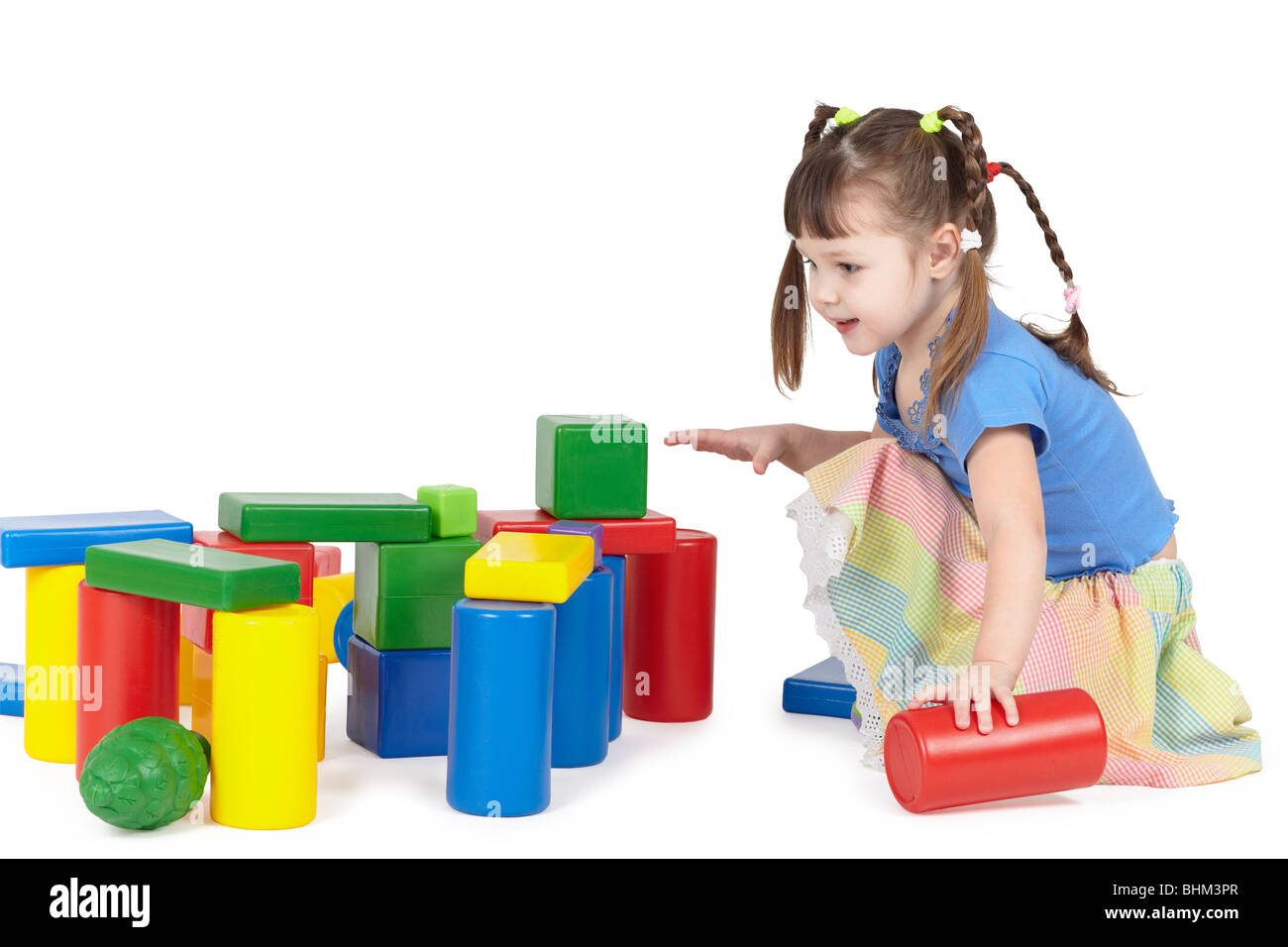 Girl playing with color toys on white background Stock Photo - Alamy