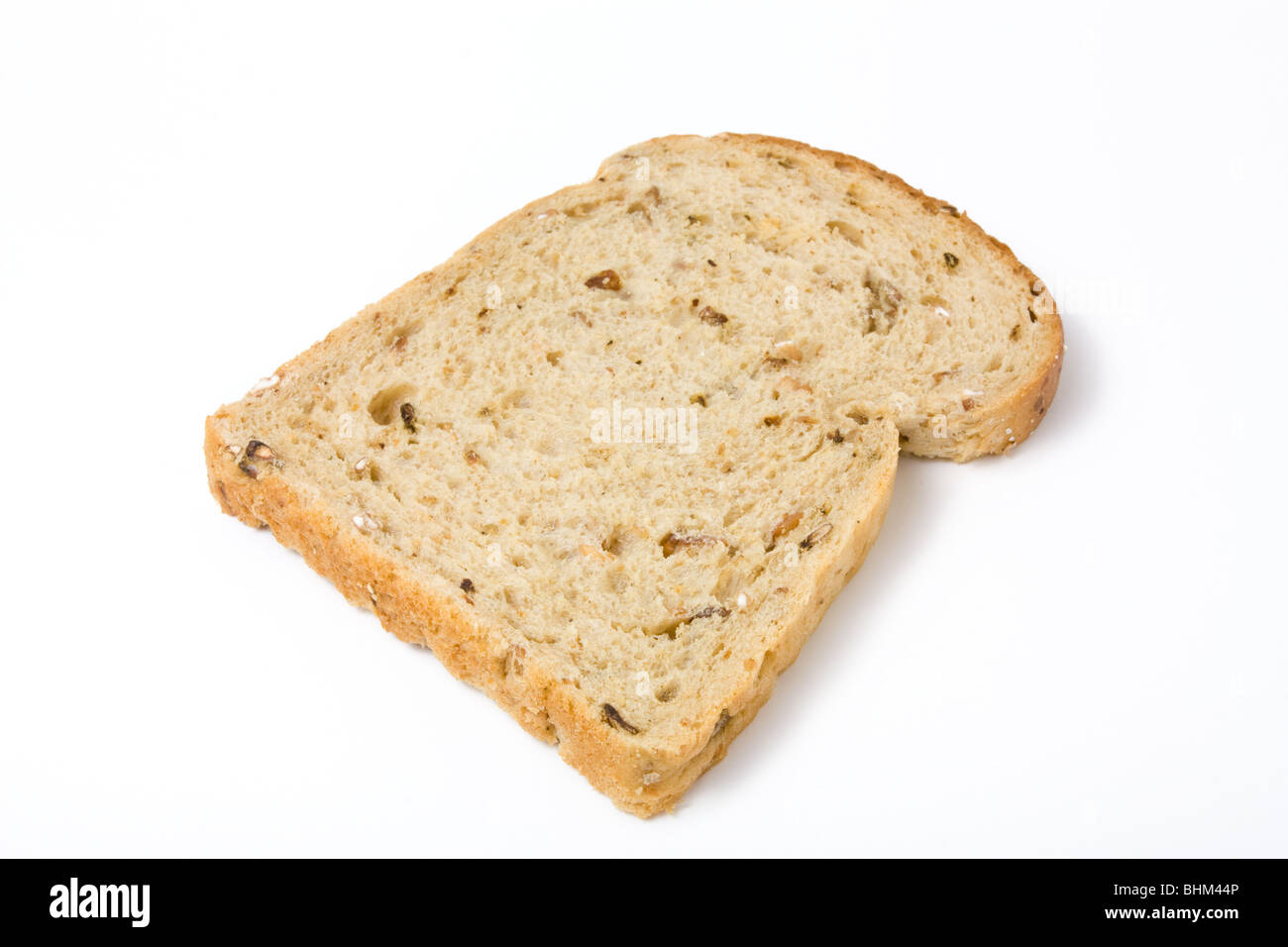 Slice of Granary bread from low viewpoint isolated against white ...