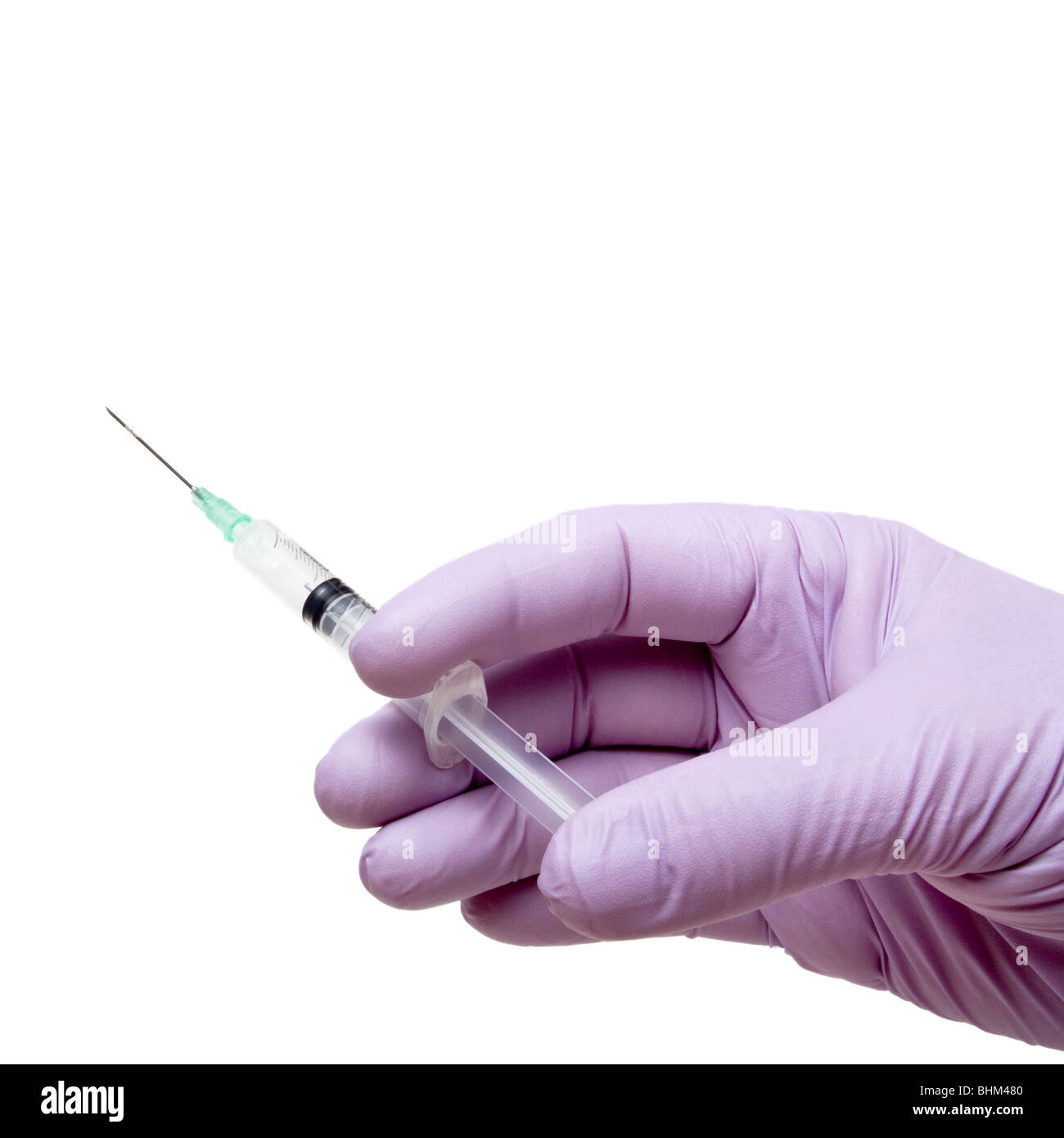 Purple latex free nitrile gloved male hand holding hypodermic needle ...