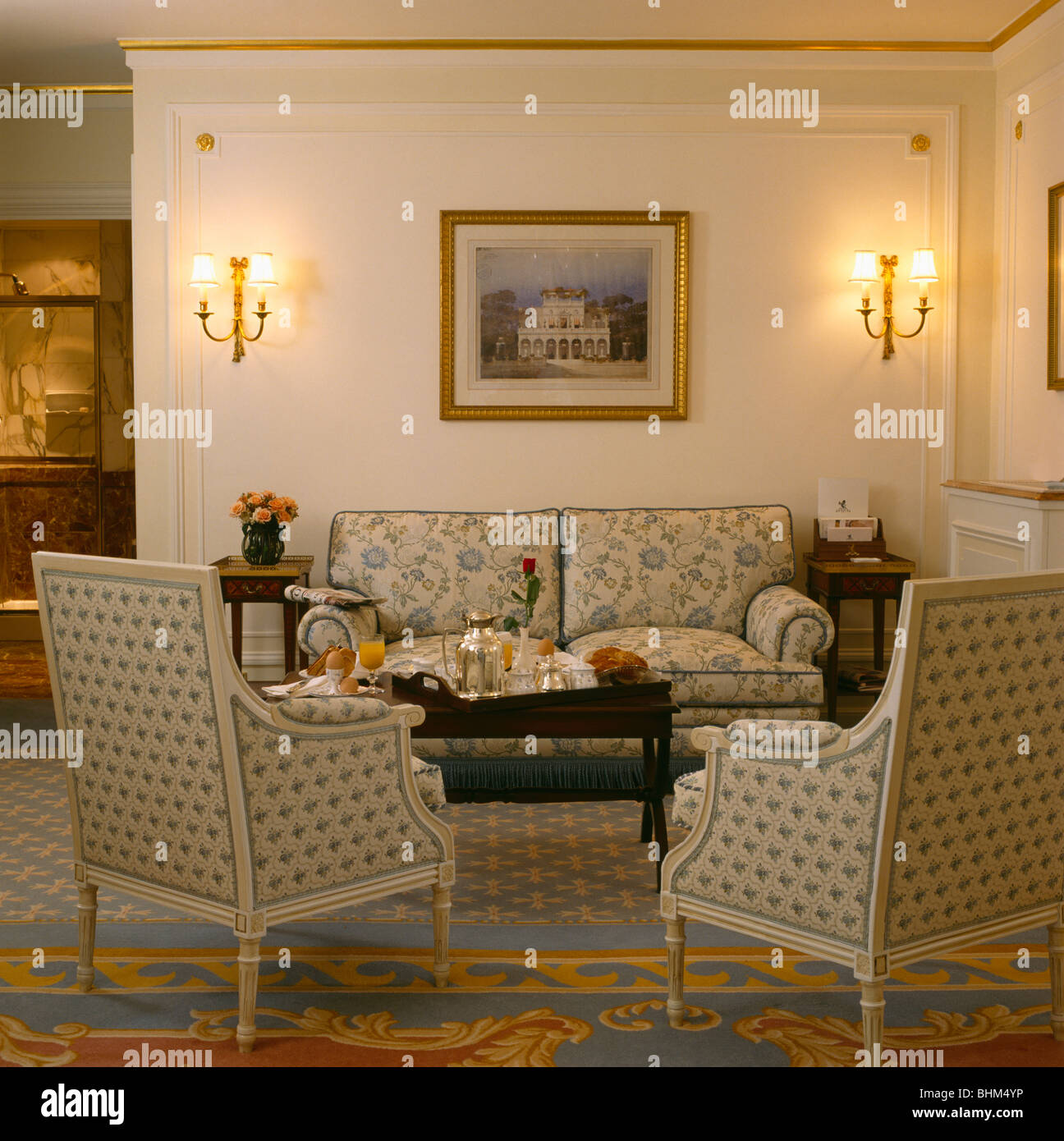 Lighted wall-lights above sofa in townhouse living room Stock Photo - Alamy