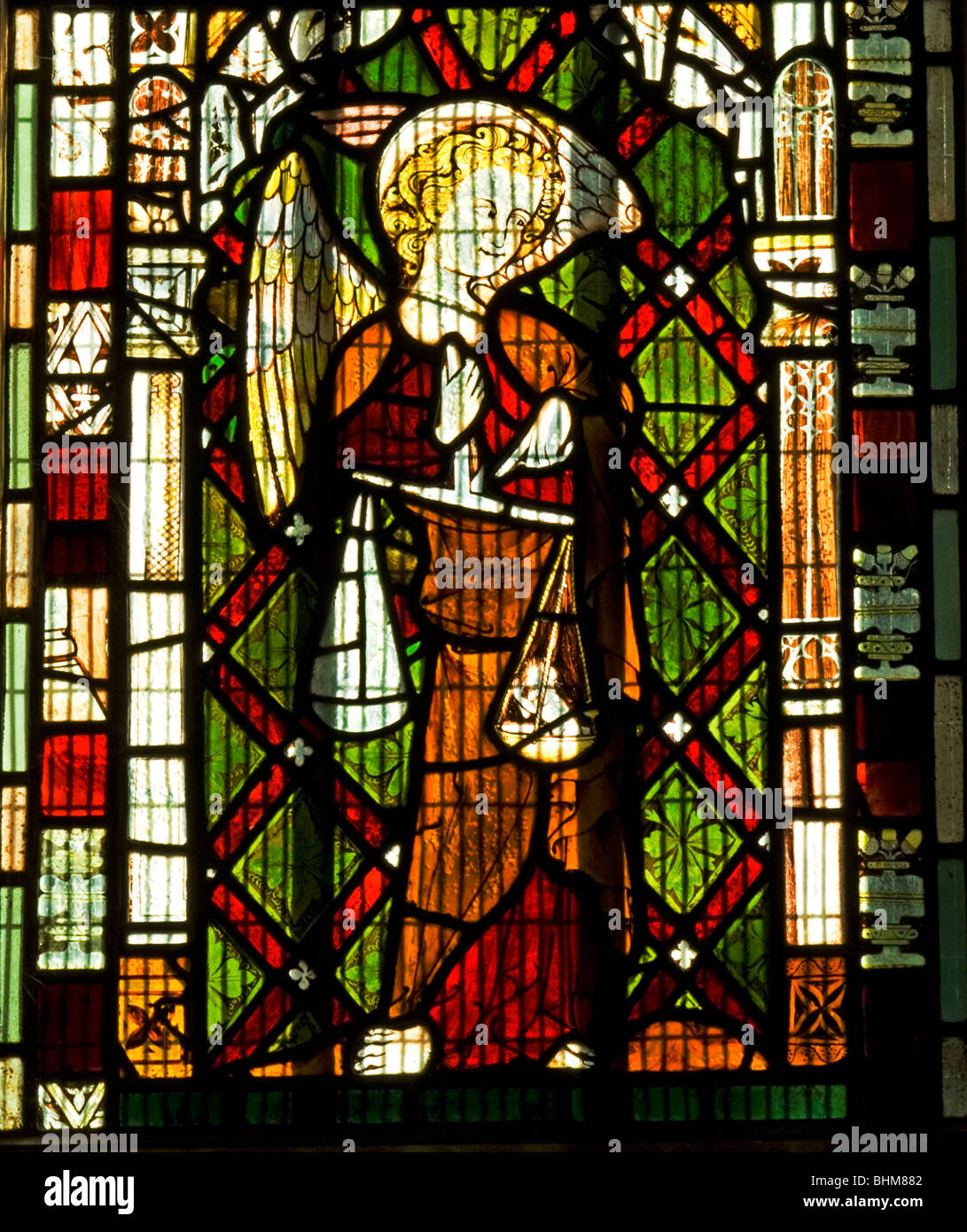 Medieval stained glass depicting St. Michael the Archangel wighing the ...