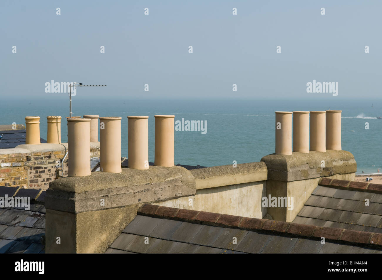 Chimney stacks and pot on a natural slate roof along with a television ...