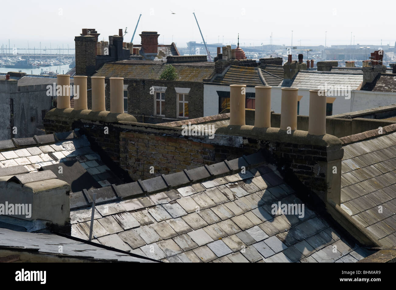 Chimney stacks and pot on a natural slate roof Stock Photo - Alamy