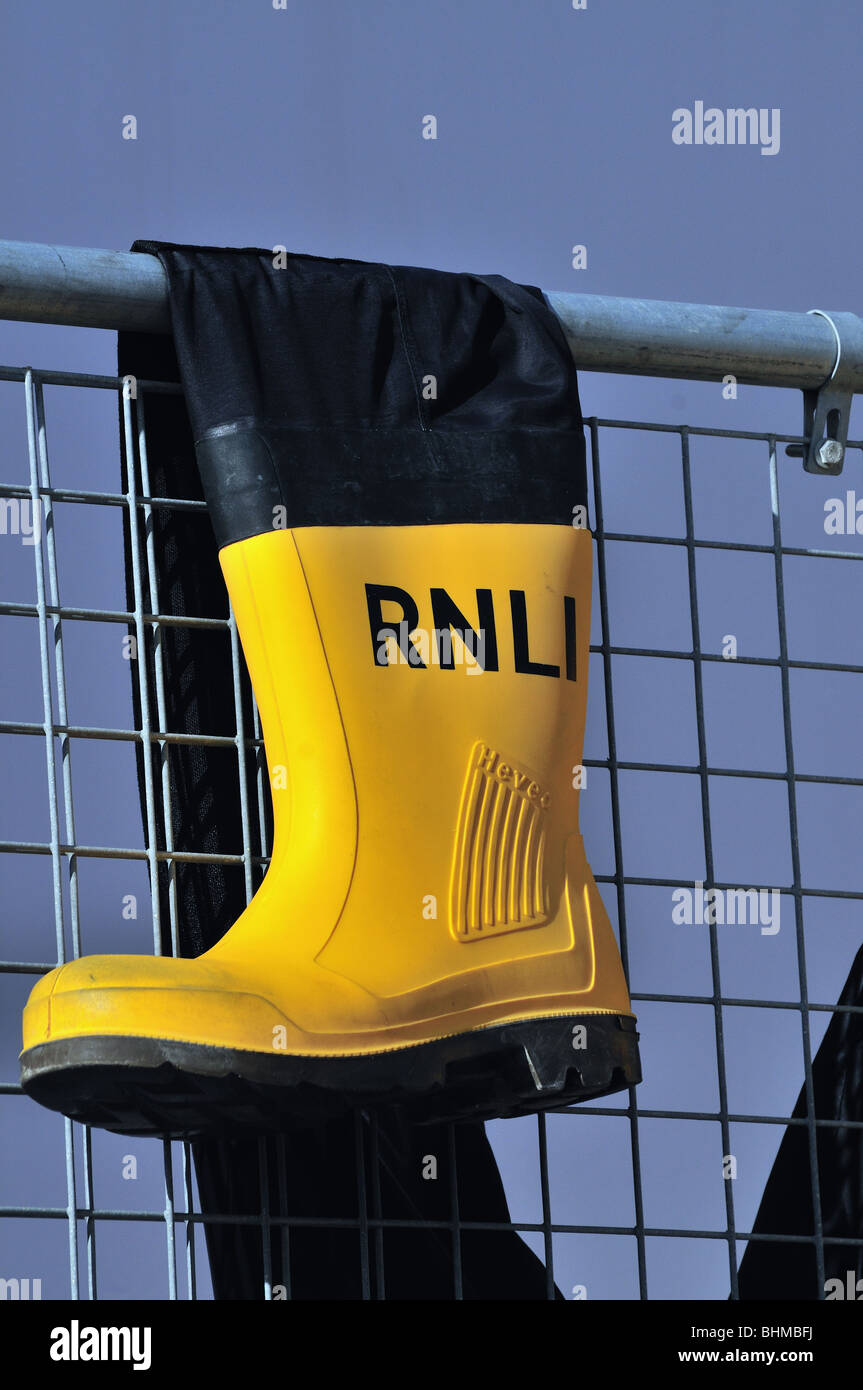 RNLI yellow rubber boots over fence Stock Photo - Alamy