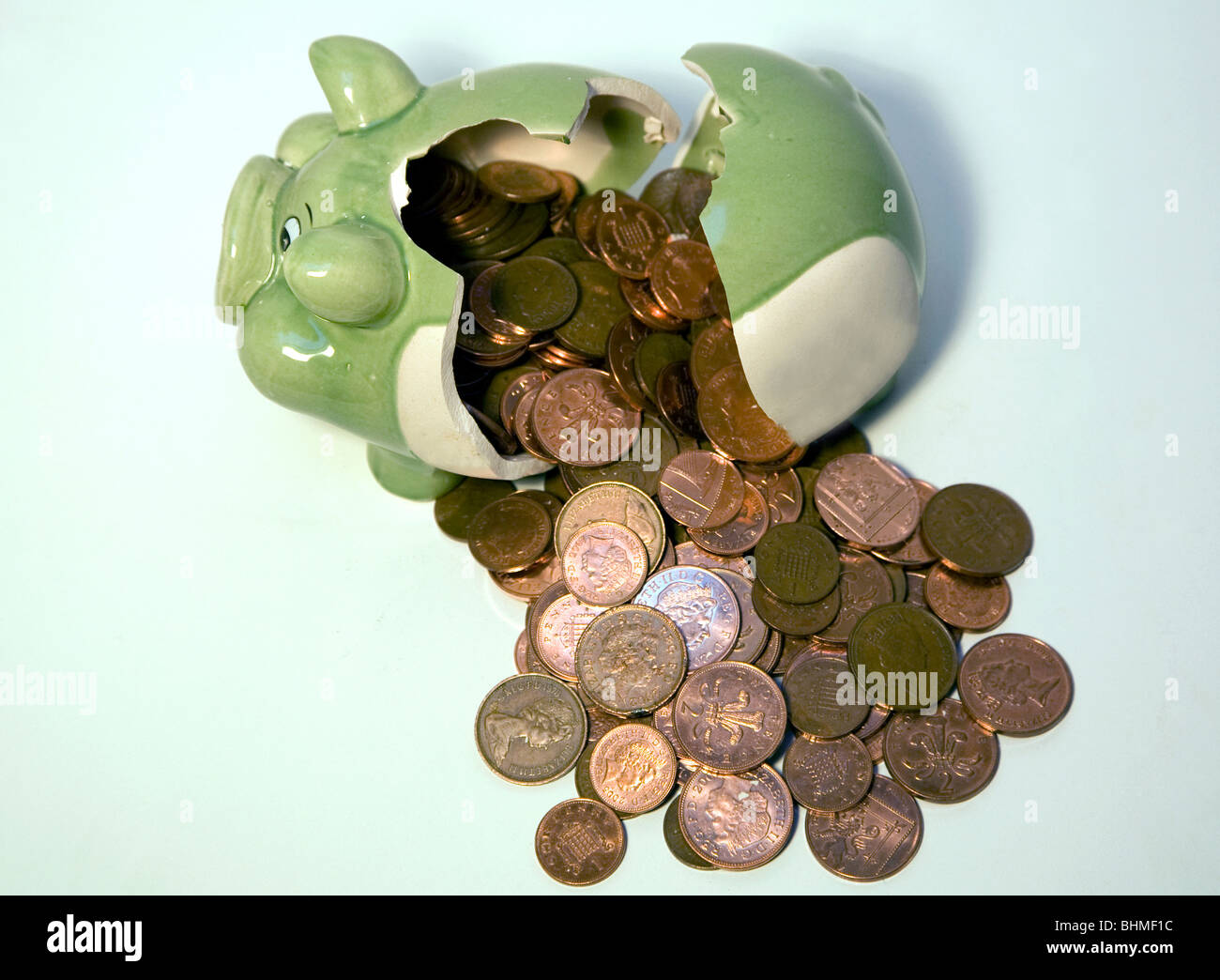 Broken piggy bank with coins Stock Photo - Alamy
