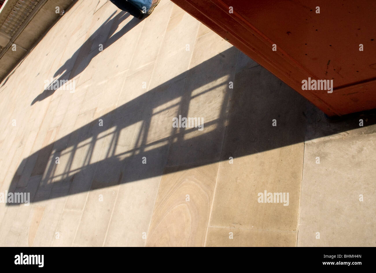 Long shadows of a Red Telephone Box in London Stock Photo - Alamy