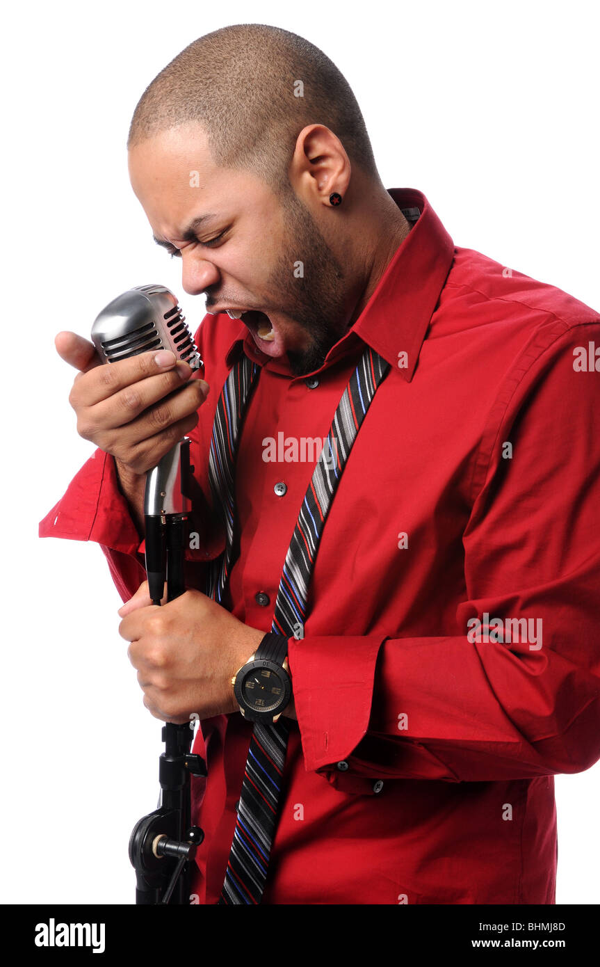 Young African American man singing into vintage microphone Stock Photo ...