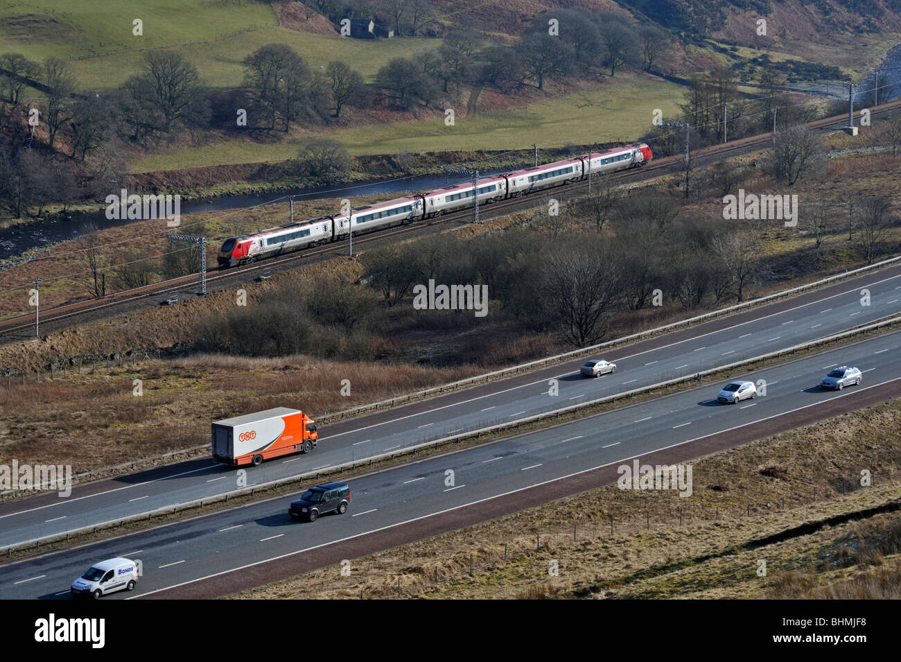 Road and rail in the Lune Gorge. M6 and West Coast Main Line. Cumbria ...