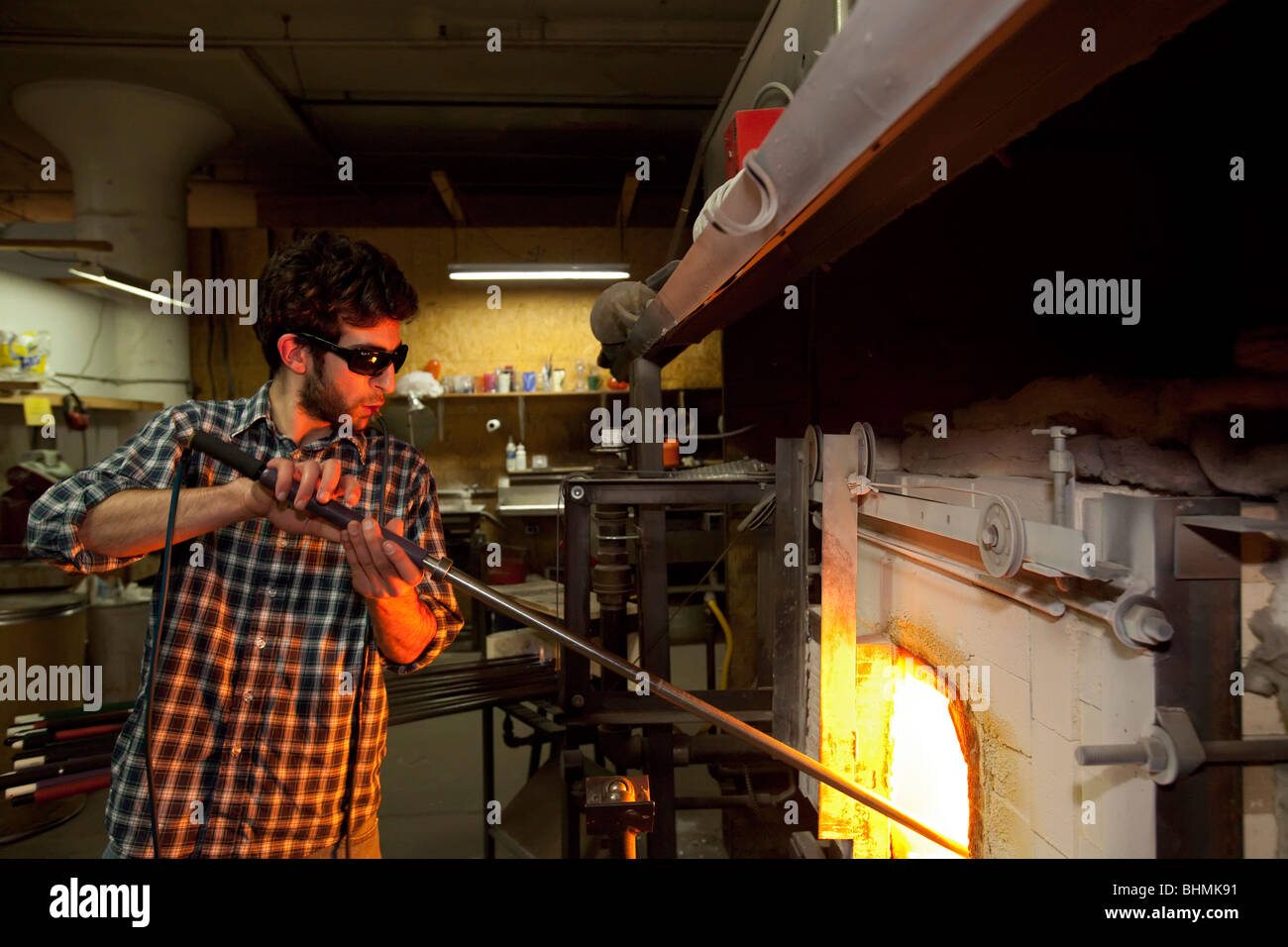 Detroit, Michigan - Paul Abowd heats glassware in a furnace at the ...