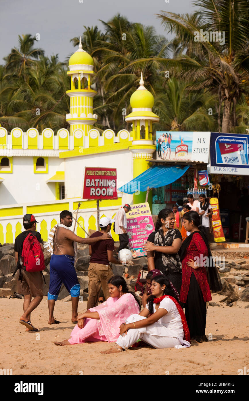 India, Kerala, Kovalam, Samudra Beach, Indian tourists sat on beach ...