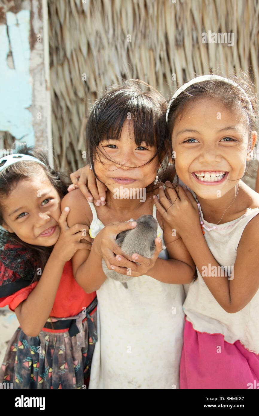 Native village children holding a puppy; Darocotan Island; Bacuit ...