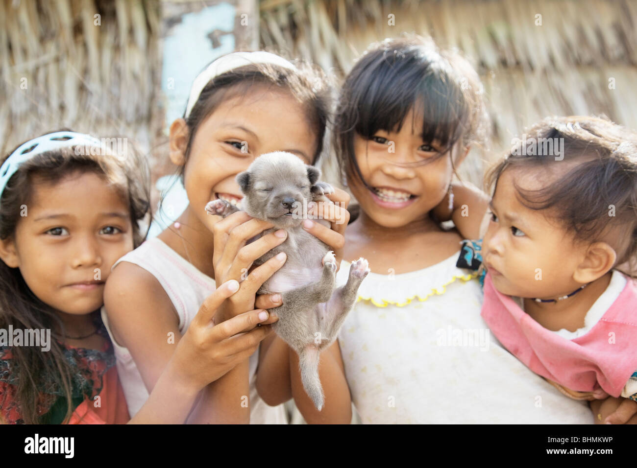 Native village children holding a puppy; Darocotan Island; Bacuit ...