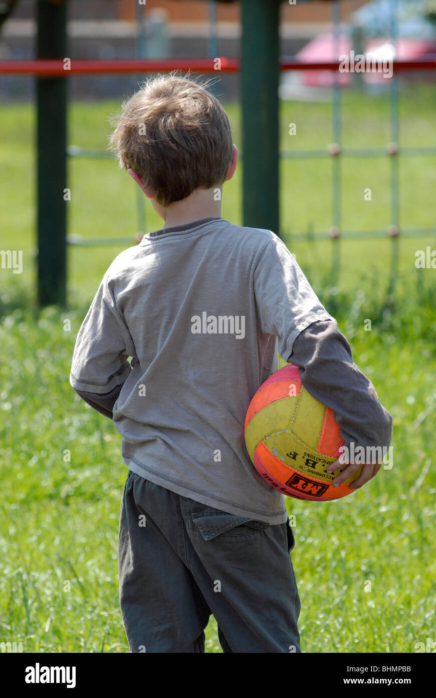 Boy playing with a ball in the park Stock Photo - Alamy
