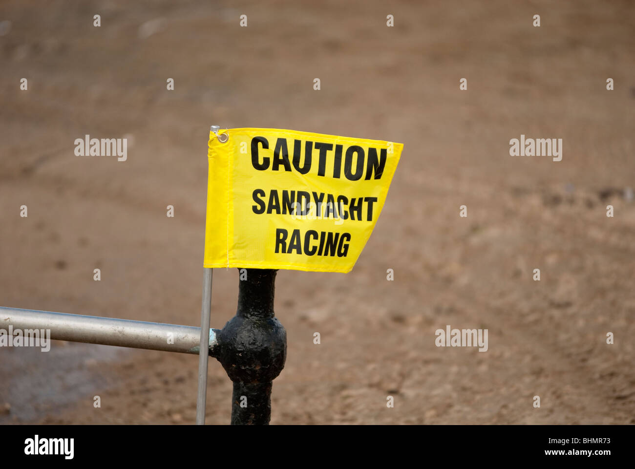 Caution Sandyacht racing yellow warning flag Stock Photo - Alamy