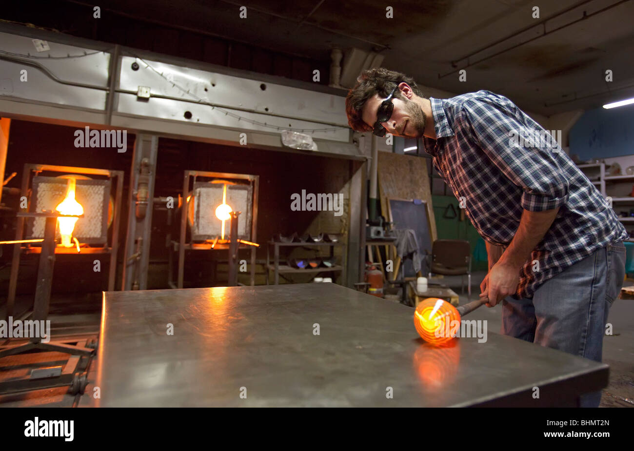 Detroit, Michigan - Paul Abowd works on a glass bowl at the Michigan ...