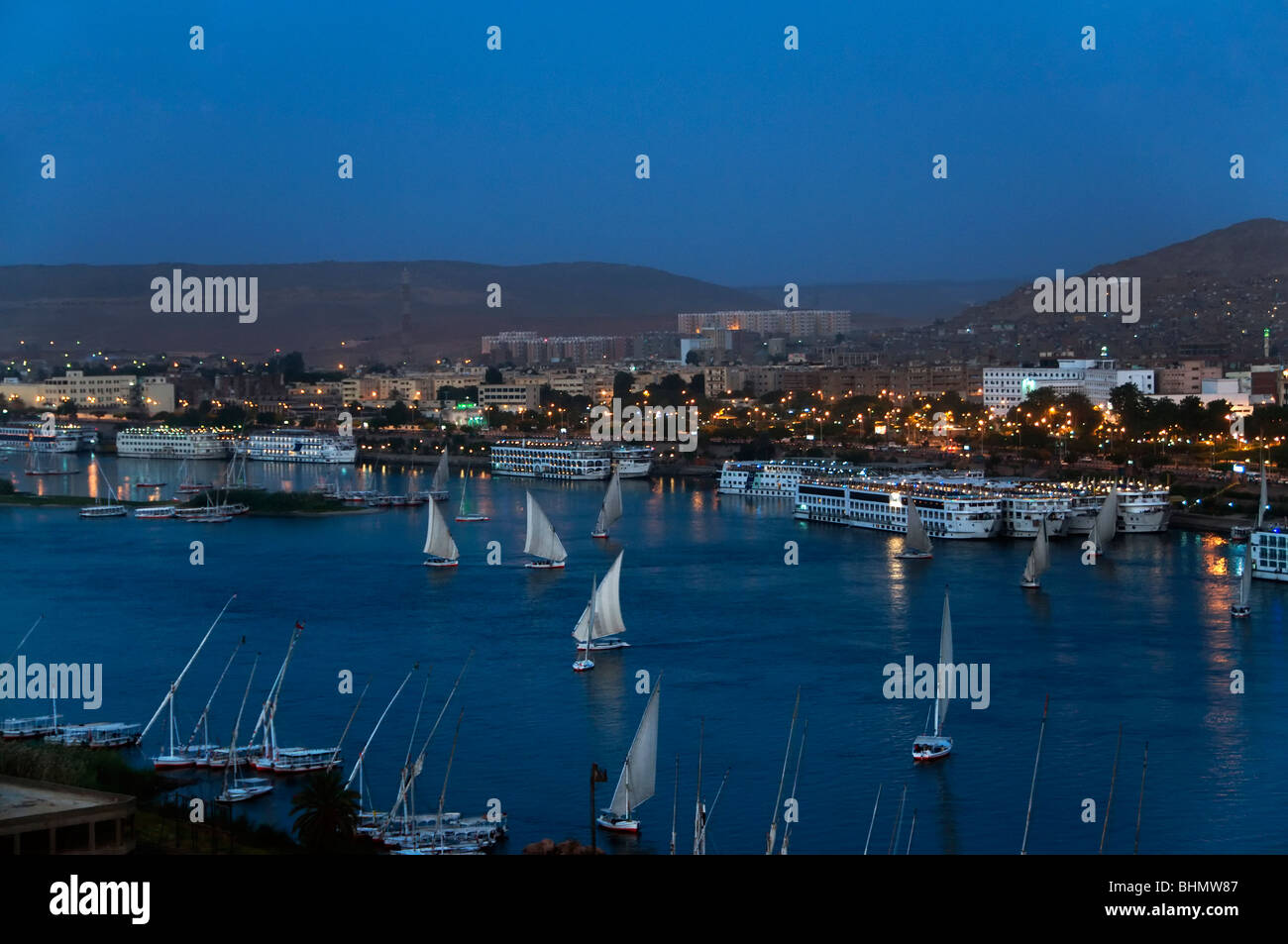Aswan Night View Feluccas sailing on the Nile river, Egypt Stock Photo ...