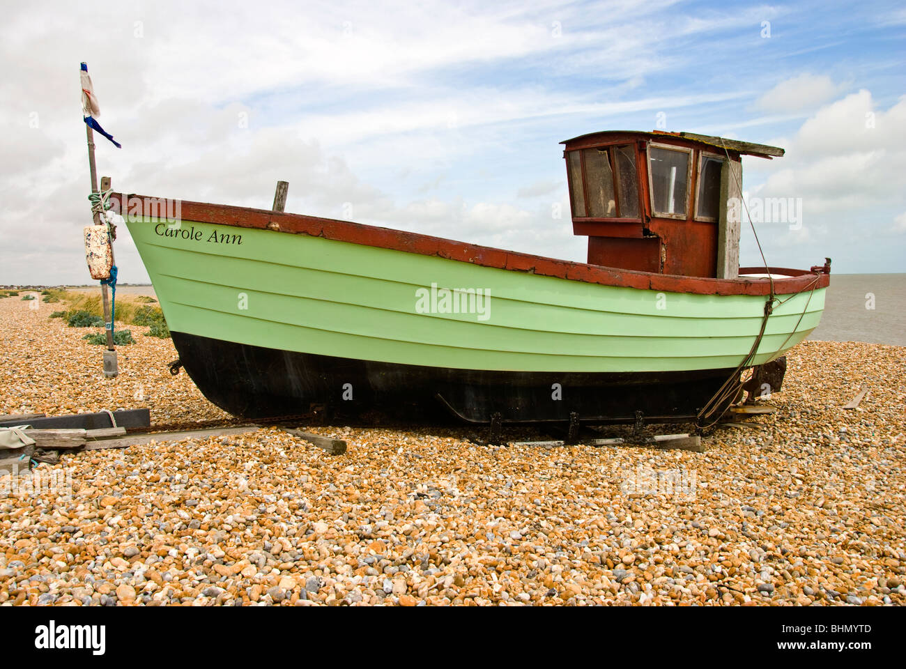 Pea green boat beached on shingle Stock Photo - Alamy