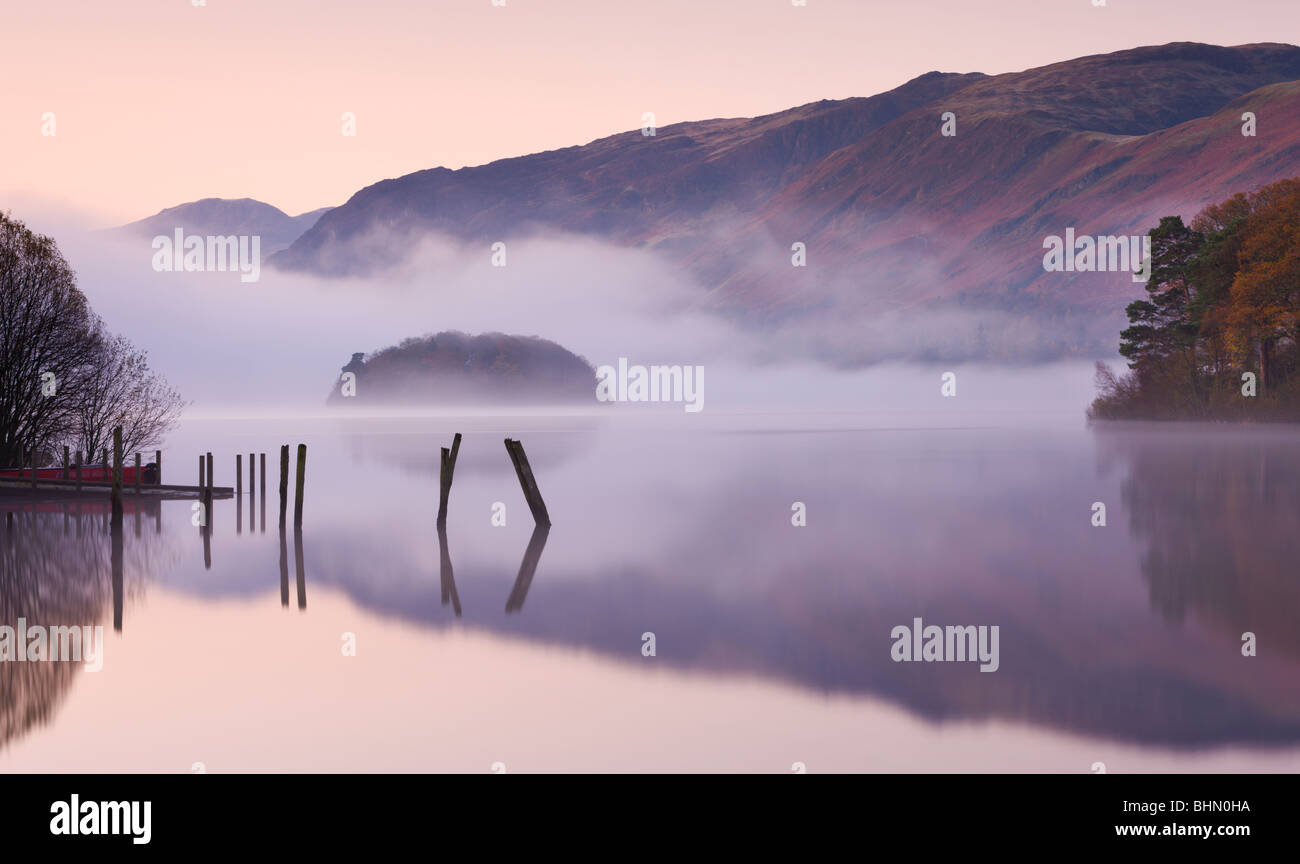 Mist surrounds a peaceful Derwent Water at dawn, Lake District National ...