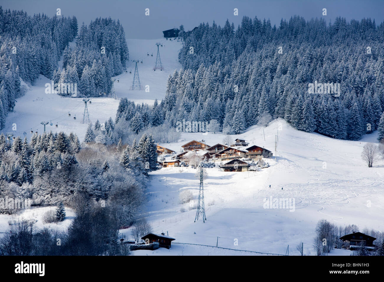 Snow scene, chalets, cable-car, hillside, Megève, France Stock Photo ...