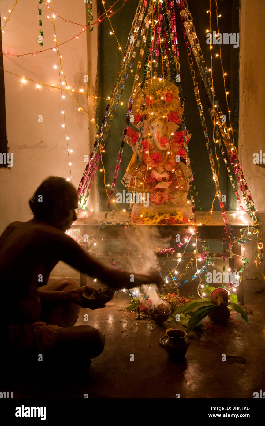 A Brahmin blesses a statue of Ganesh, the elephant god of the Hindu ...