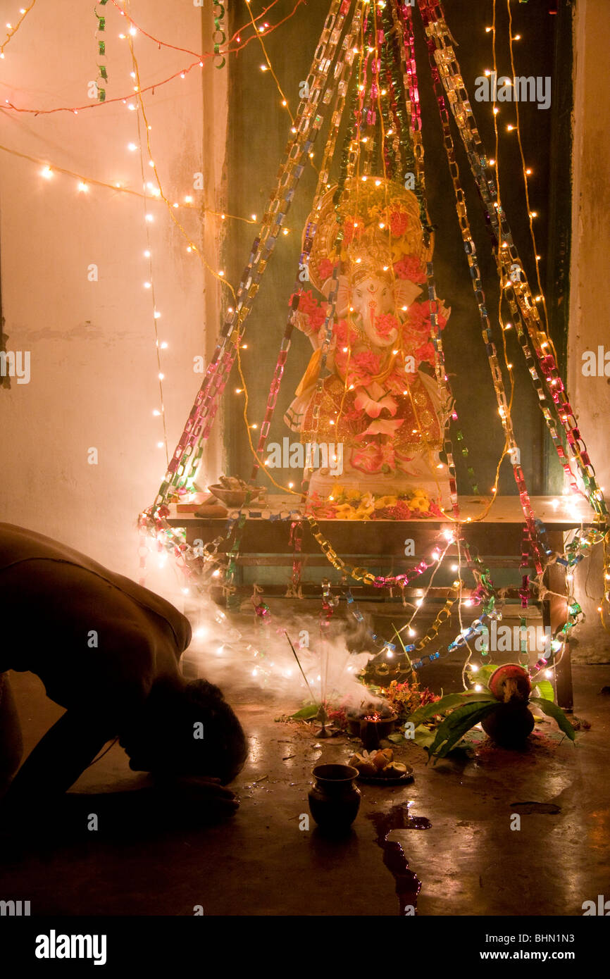A Brahmin blesses a statue of Ganesh, the elephant god of the Hindu ...