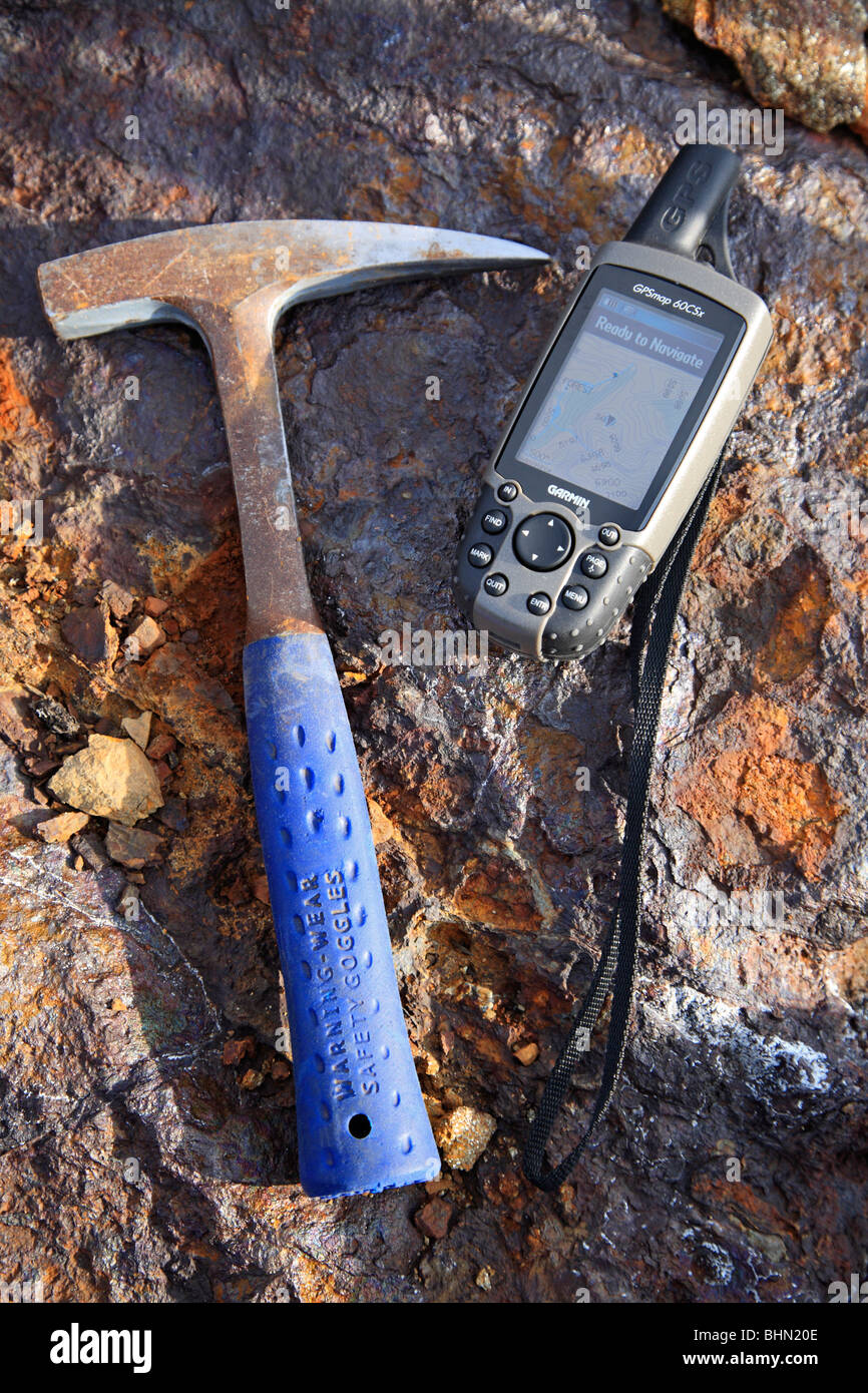 Mining exploration; geologists rock hammer and GPS unit on mineral rich ...