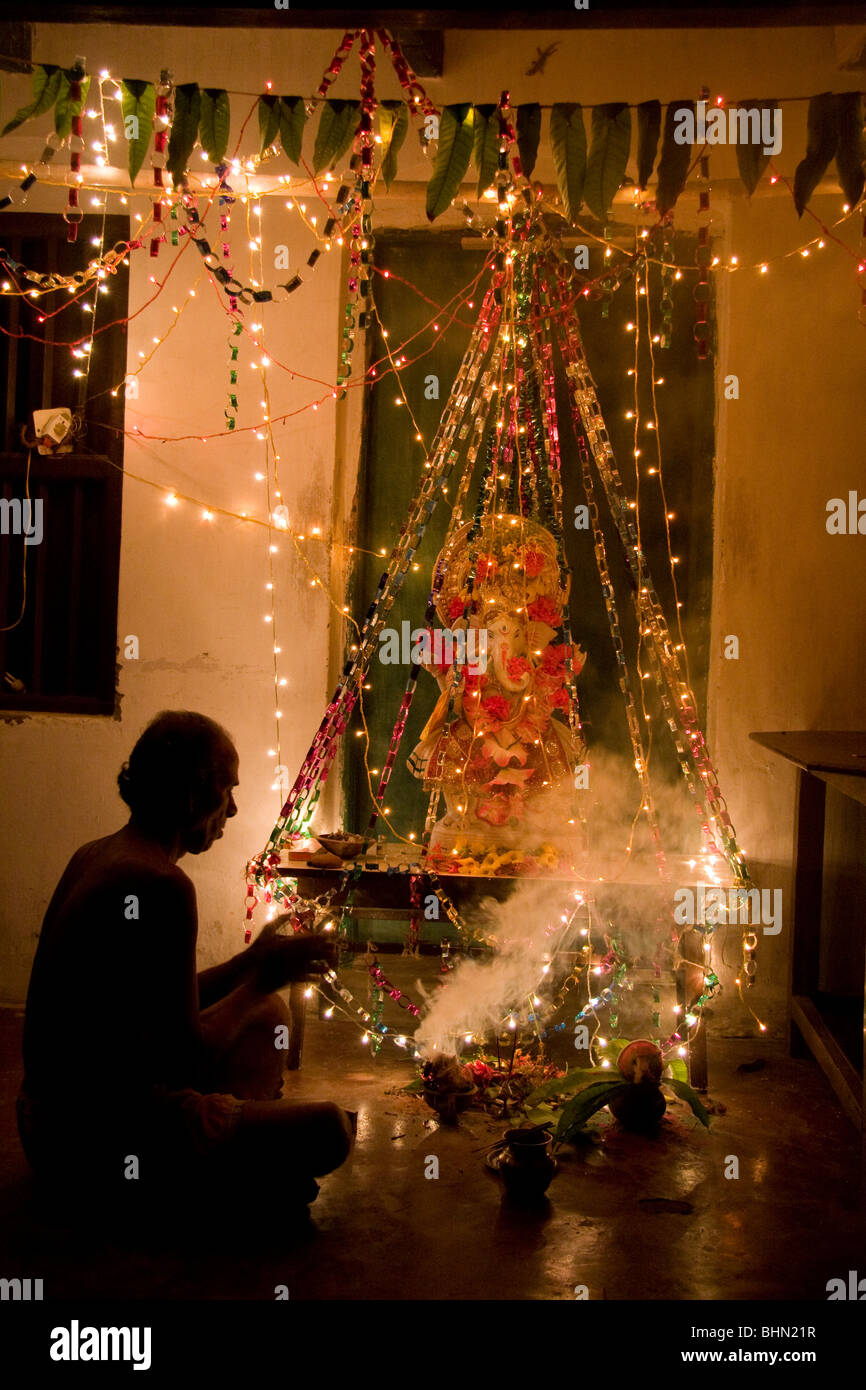 A Brahmin blesses a statue of Ganesh, the elephant god of the Hindu ...