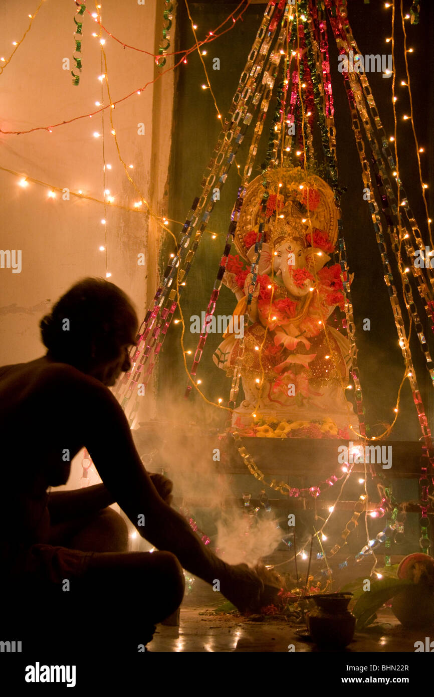 A Brahmin blesses a statue of Ganesh, the elephant god of the Hindu ...