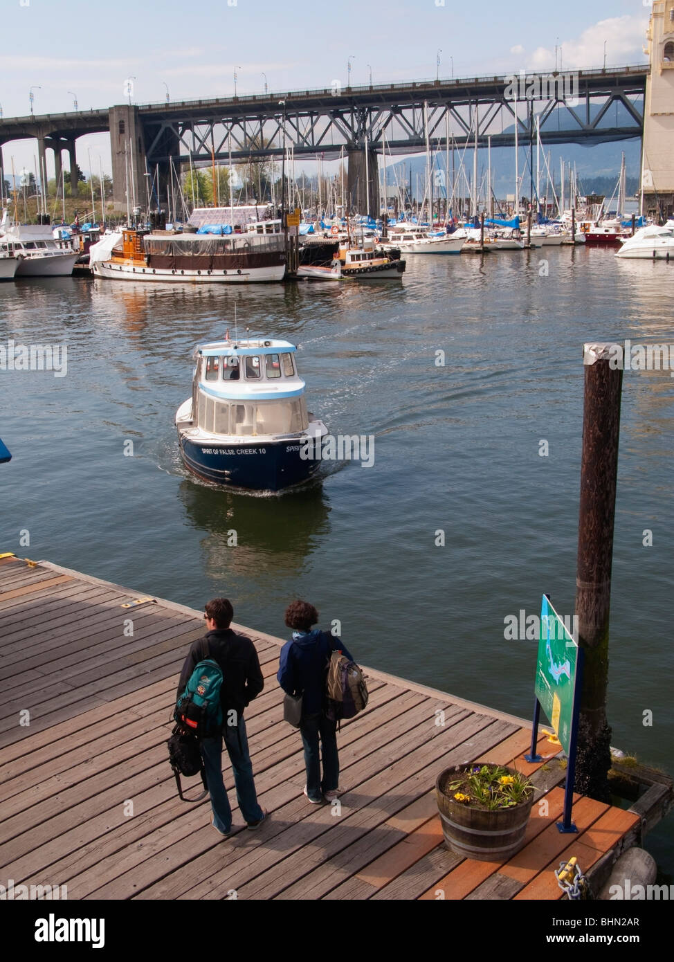 Passengers wait for a False Creek Ferries water taxi at Granville ...
