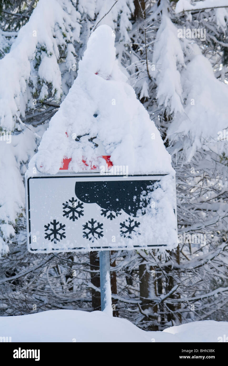Snow on road sign Stock Photo - Alamy