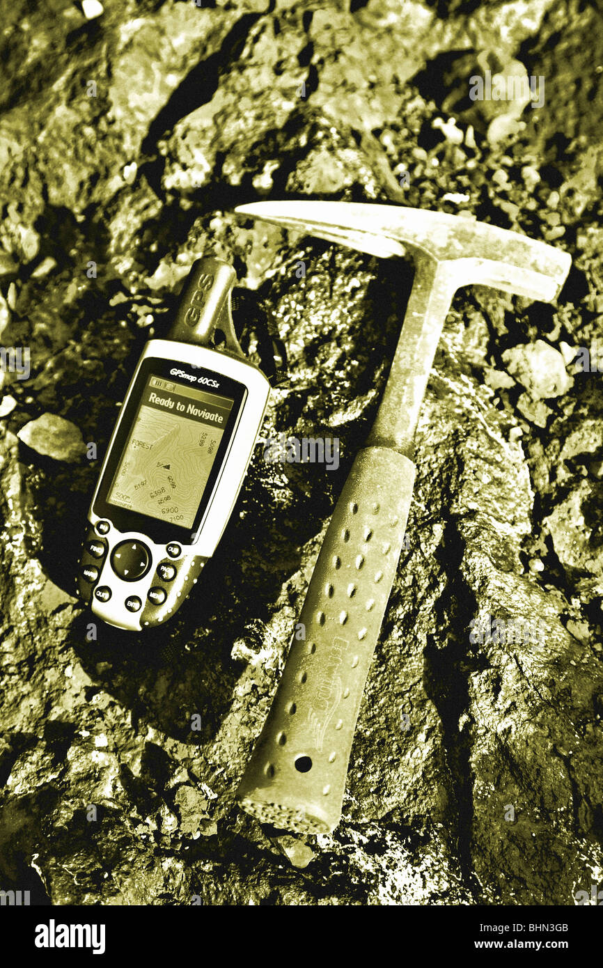 Mining exploration; geologists rock hammer and GPS unit on mineral rich ...