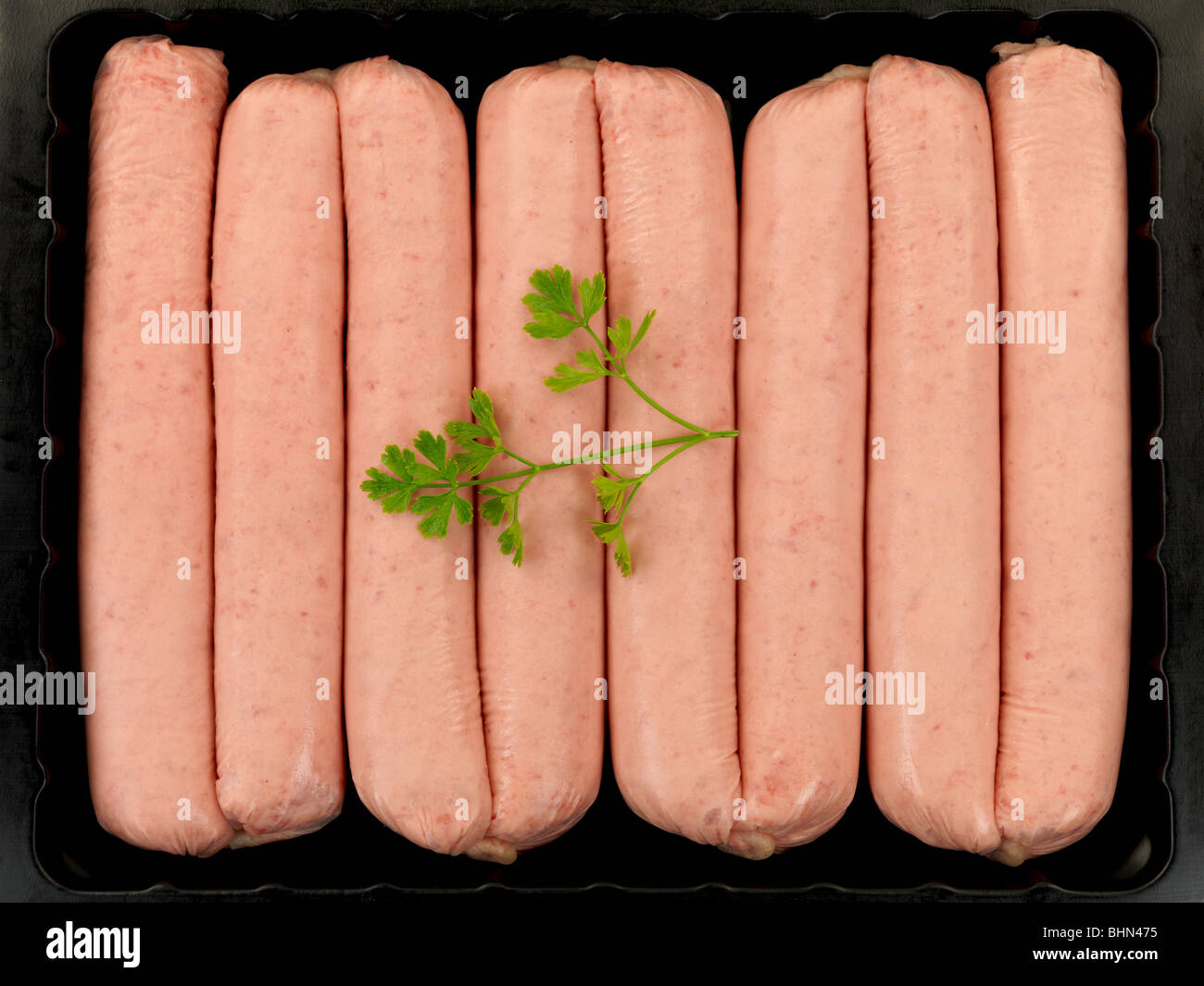 Supermarket packaged pork sausages isolated against a white background ...