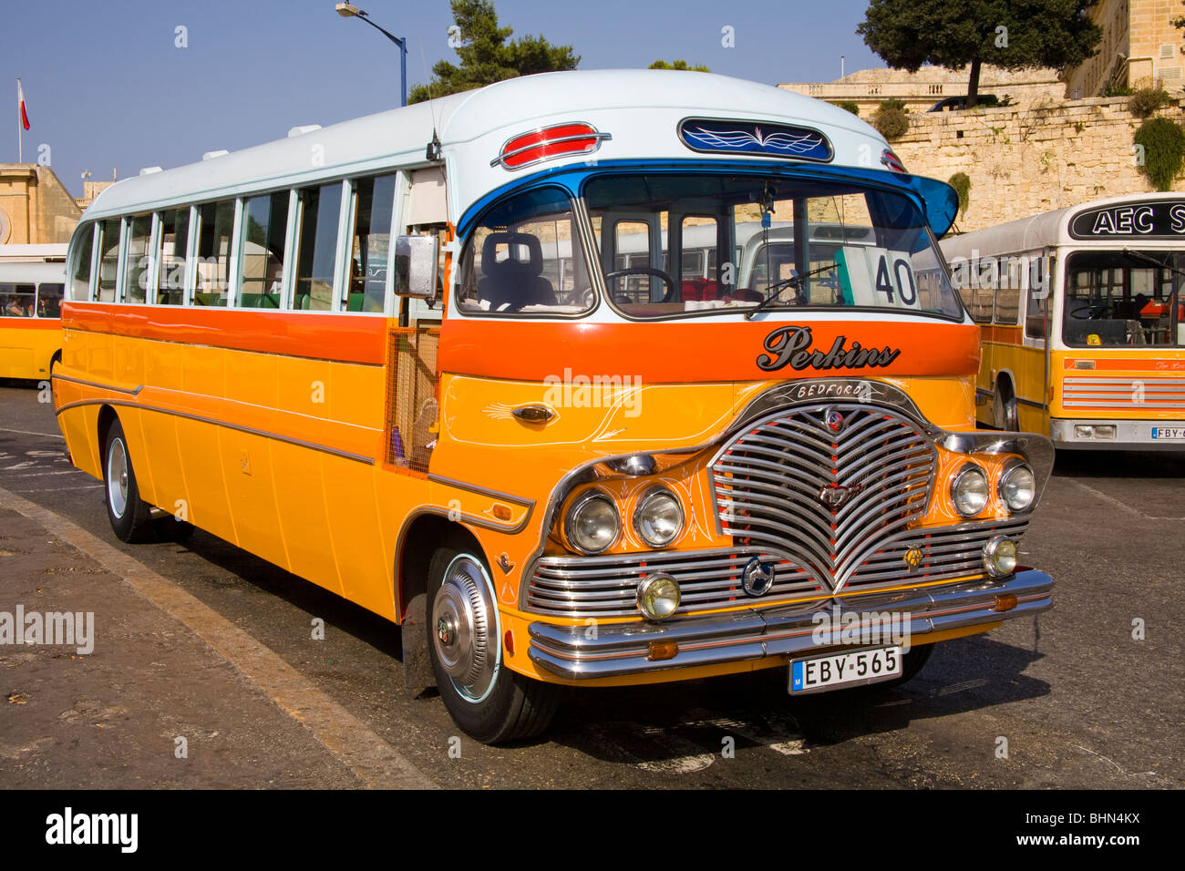 Orange+yellow public transport bus, parked at the bus terminus in ...
