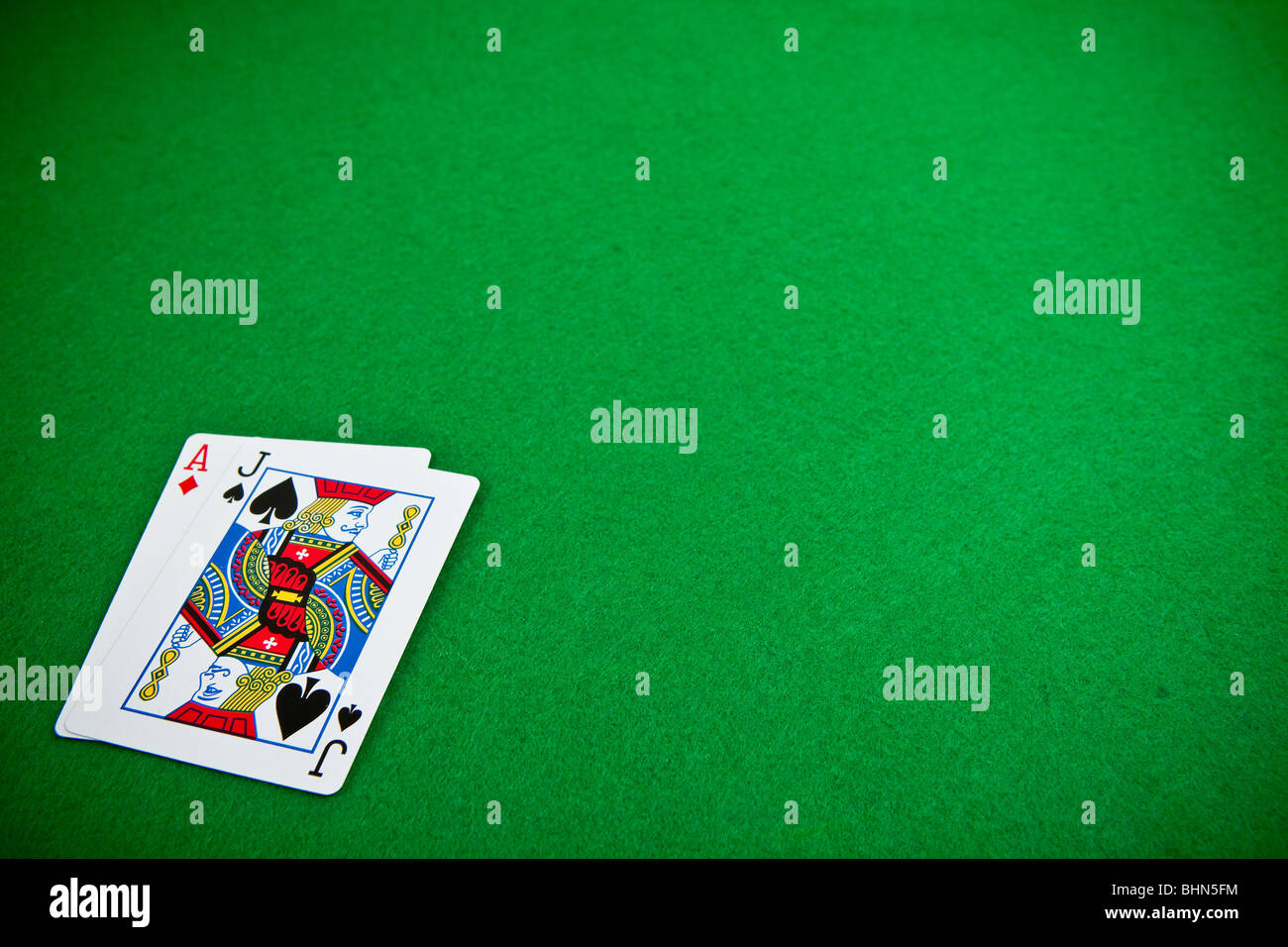 Cards over green poker table Stock Photo - Alamy