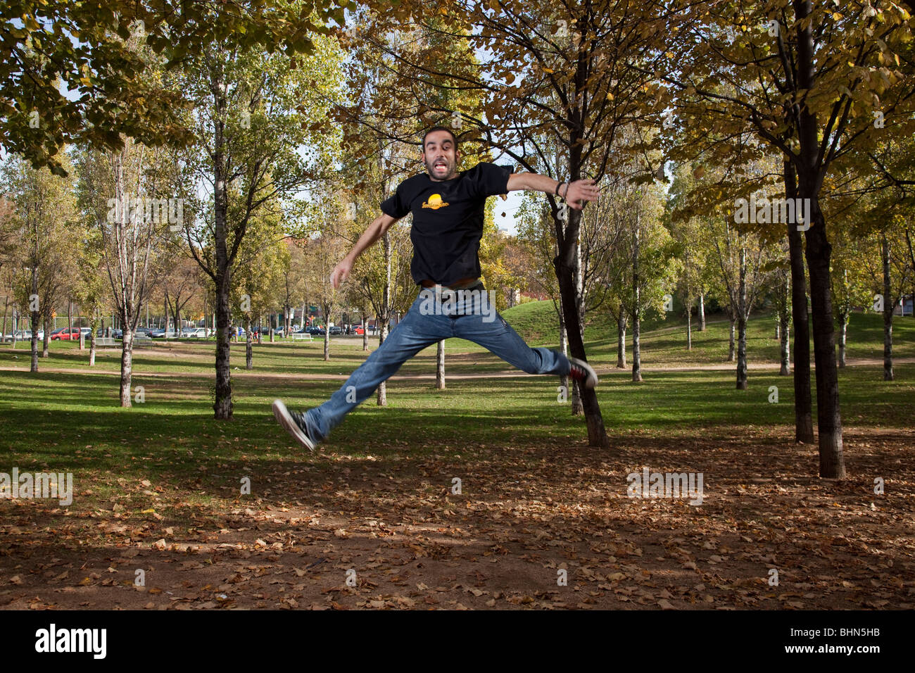 A young Man jumping in a park Stock Photo - Alamy